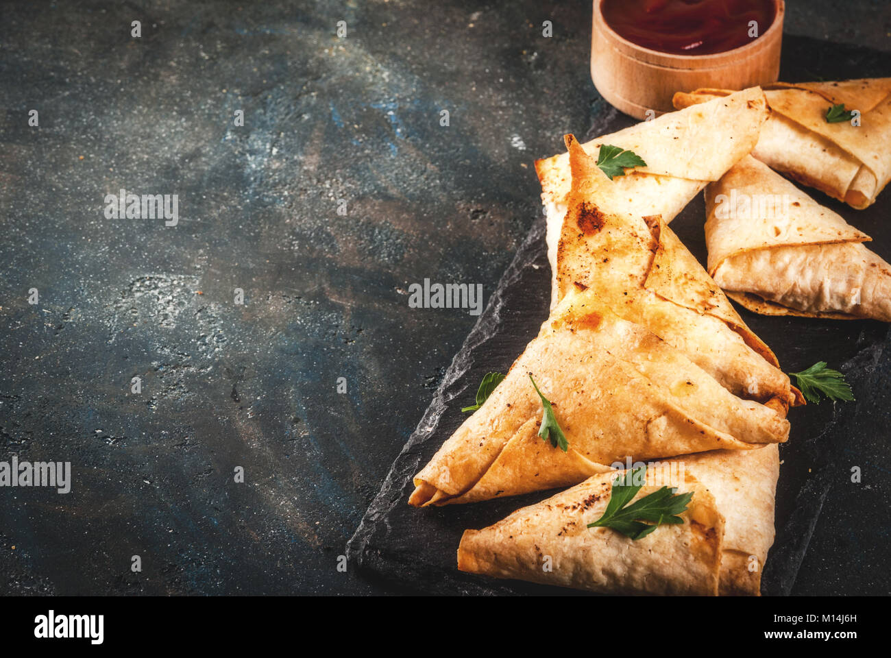 Asian food. Vegetarian samsa (samosas) with tomato sauce. Dark blue background copy space Stock ...