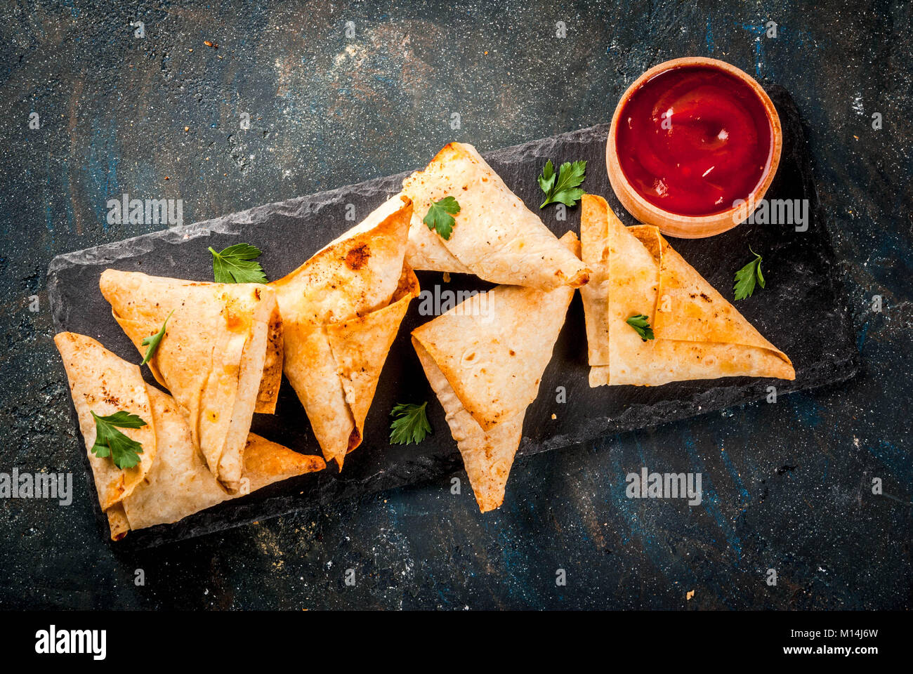 Asian food. Vegetarian samsa (samosas) with tomato sauce. Dark blue background copy space top ...