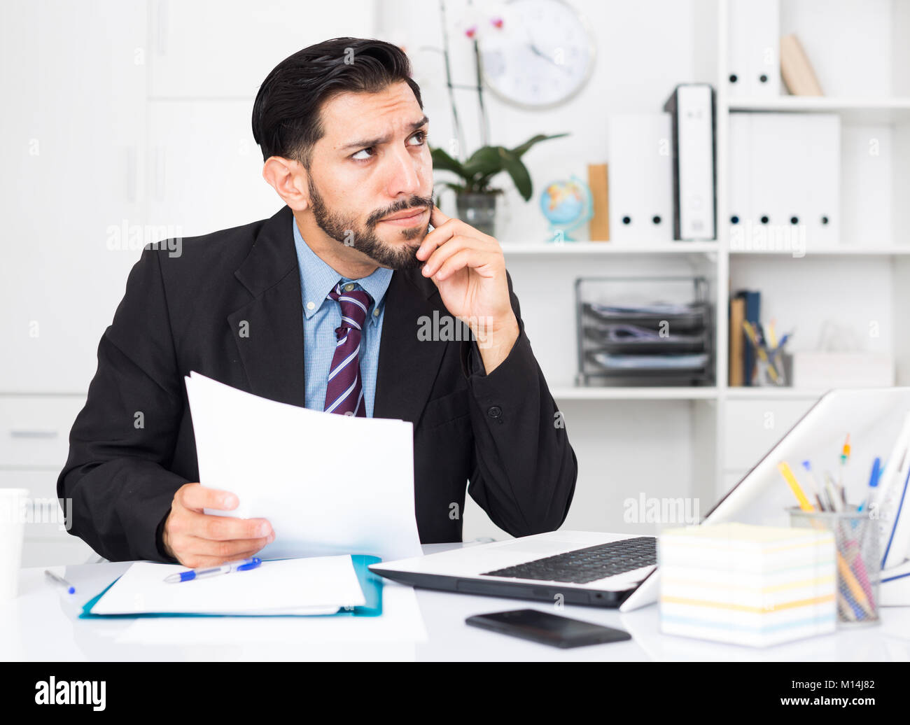 Adult businessman is sad because he is having issues at work place in ...