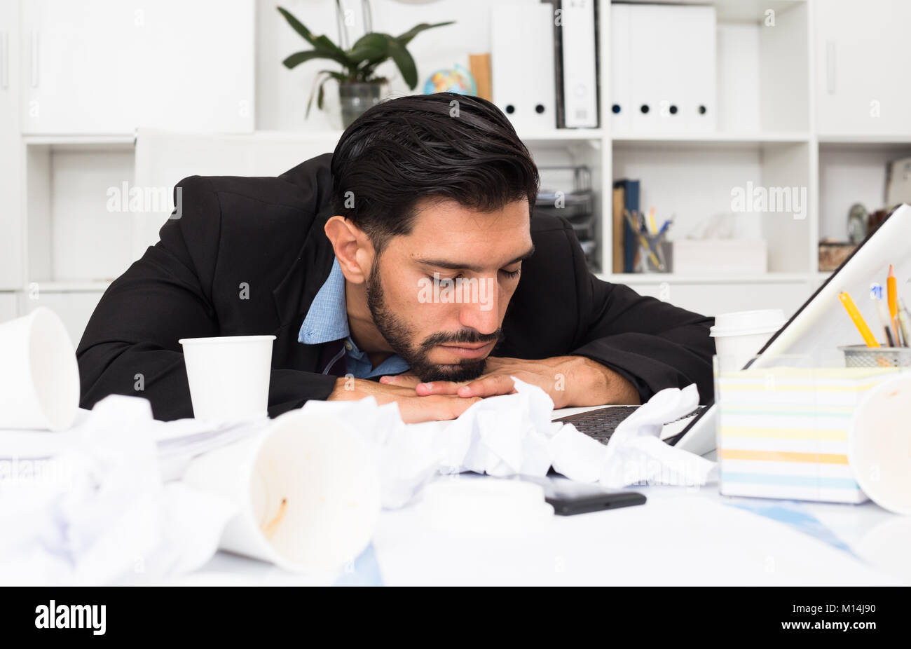 Businessman is resting after productive work day in office Stock Photo ...