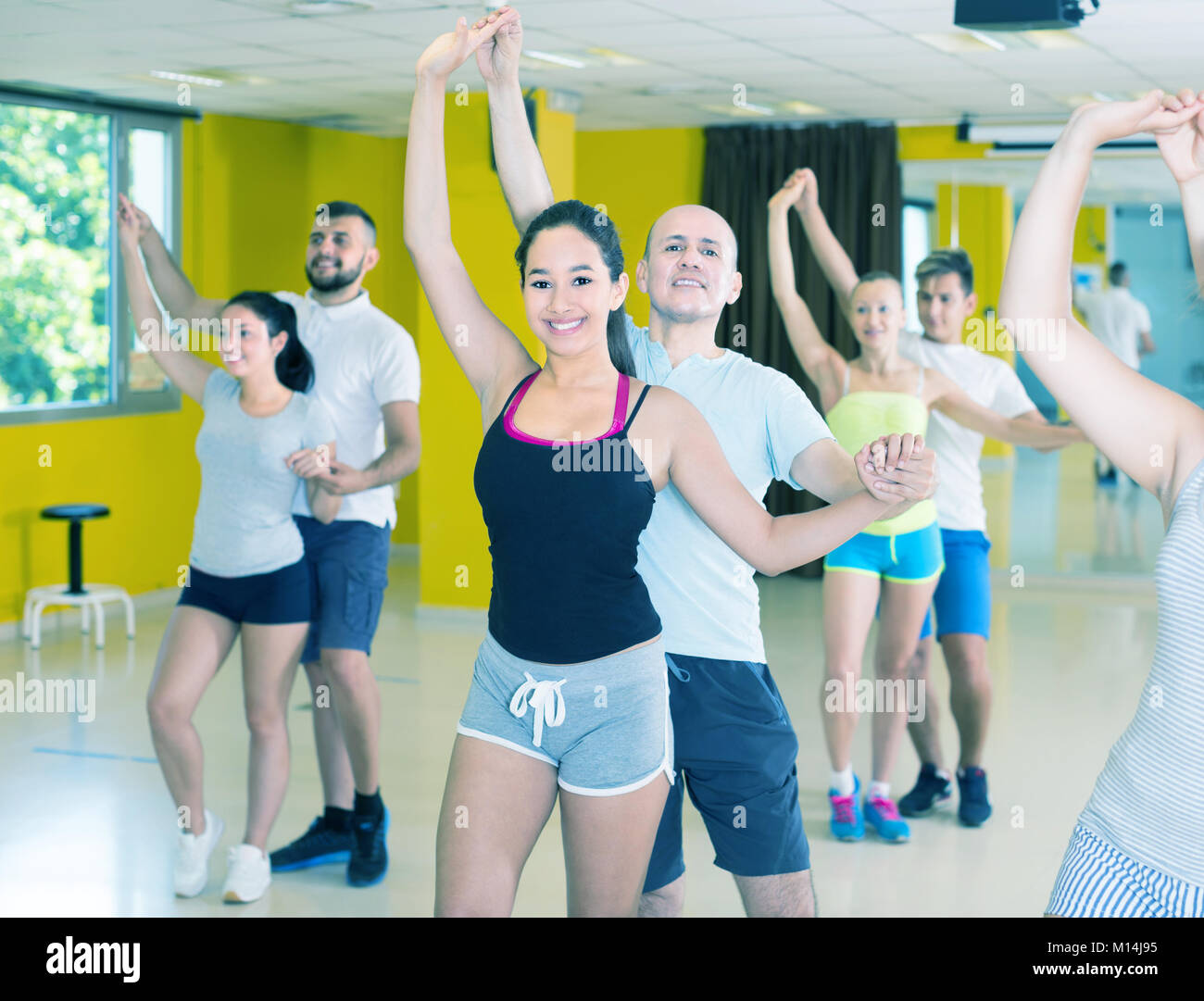 Happy people dancing salsa in dance hall Stock Photo - Alamy