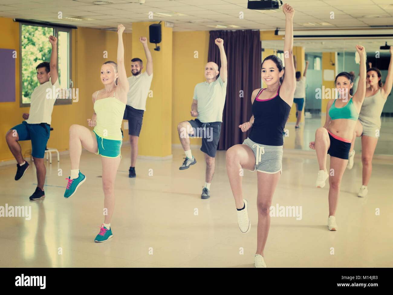 Portrait of enthusiastic people dancing zumba in dance class Stock ...