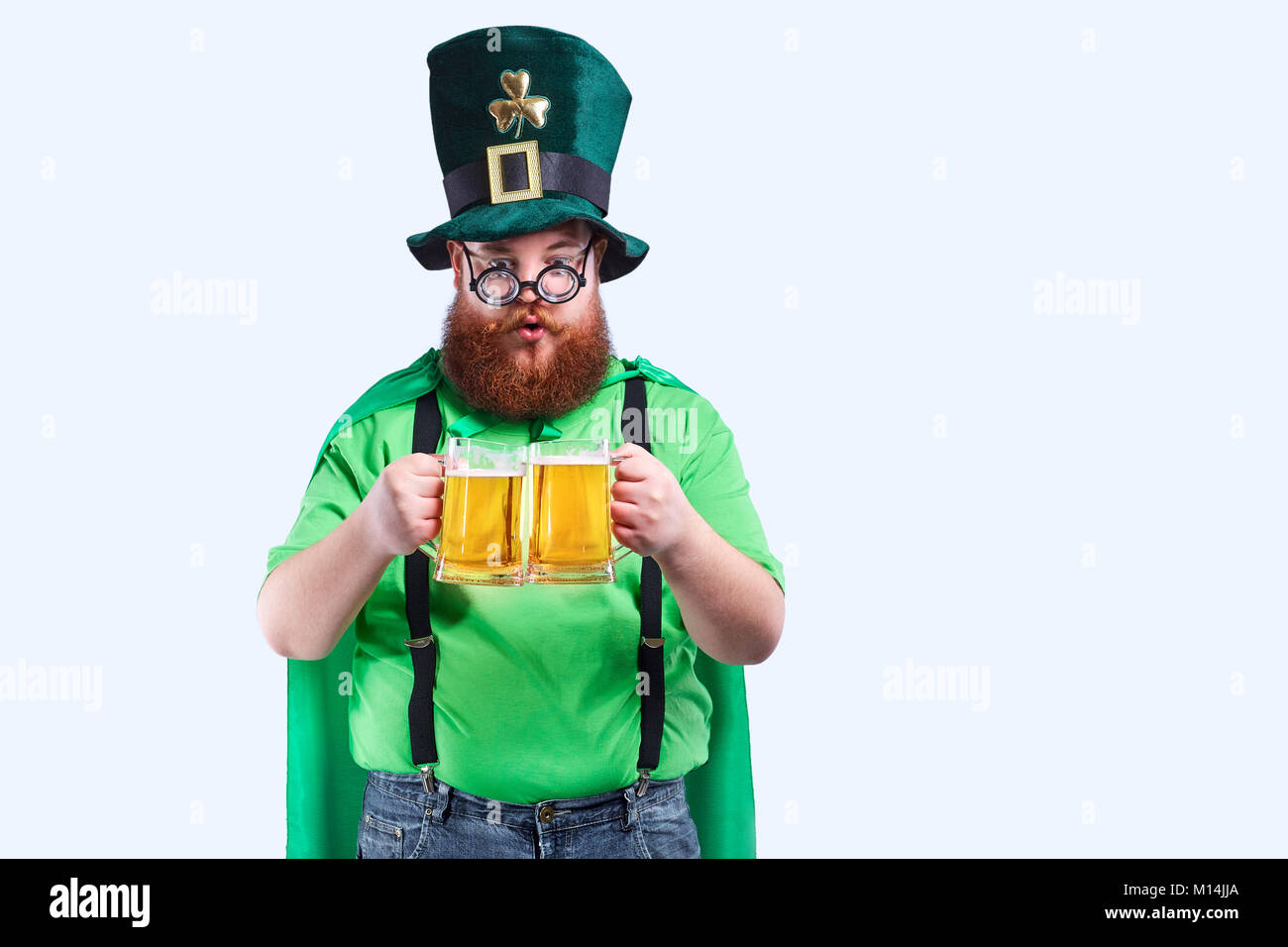 A fat man with a beard in St. Patrick's suit is smiling with a m Stock ...