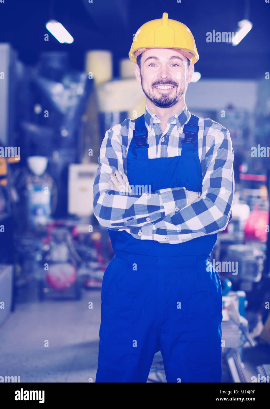 Smiling european working man demonstrating his workplace and tools at ...