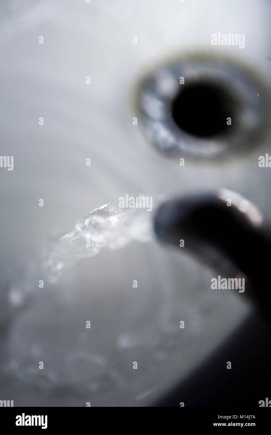 Sink with running tab water Stock Photo - Alamy