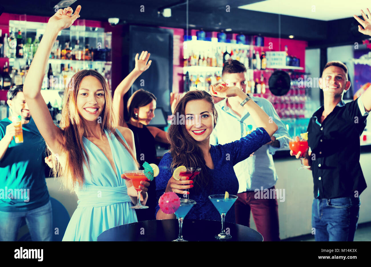 Two female are talking and drinking cocktails on the party Stock Photo ...