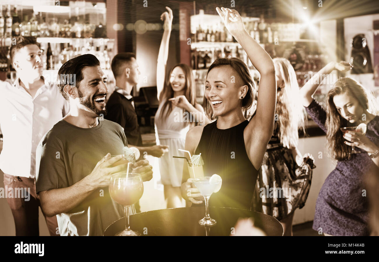 Happy cheerful positive man with woman are drinking cocktails on ...