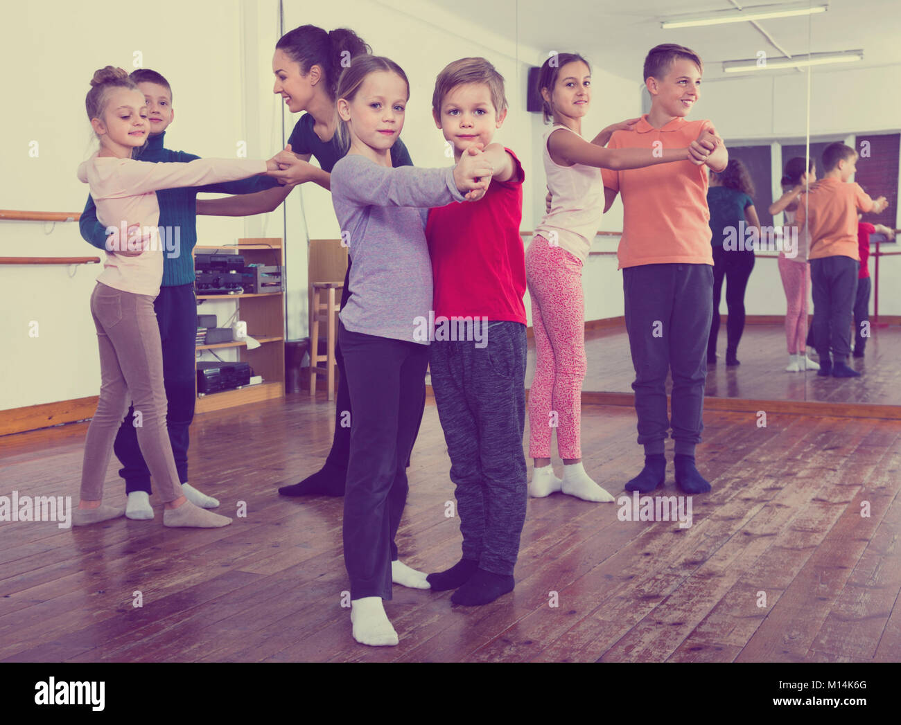 Happy glad children studying of partner dance at dance school Stock ...