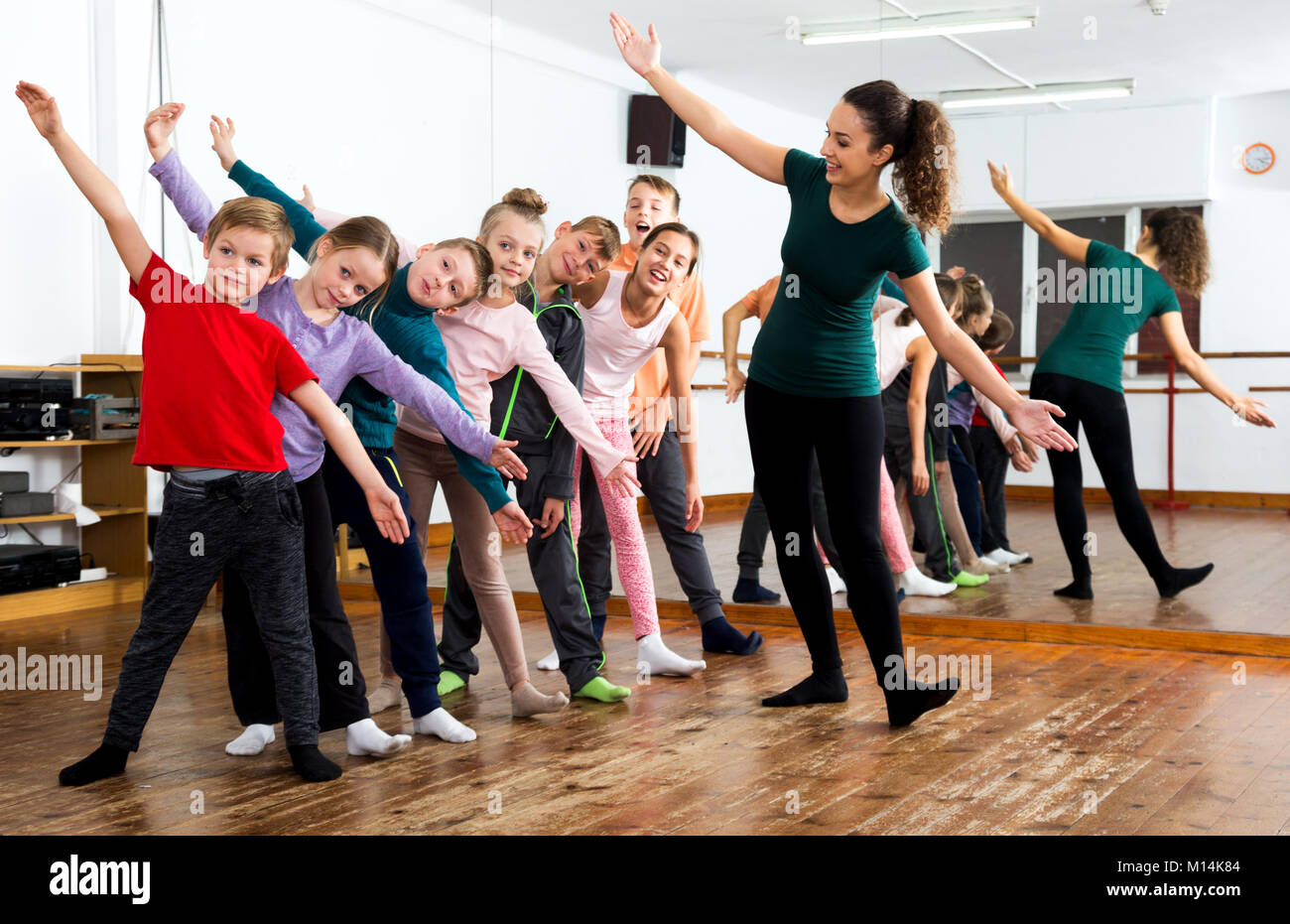 Cheerful little children studying modern style dance in class Stock ...