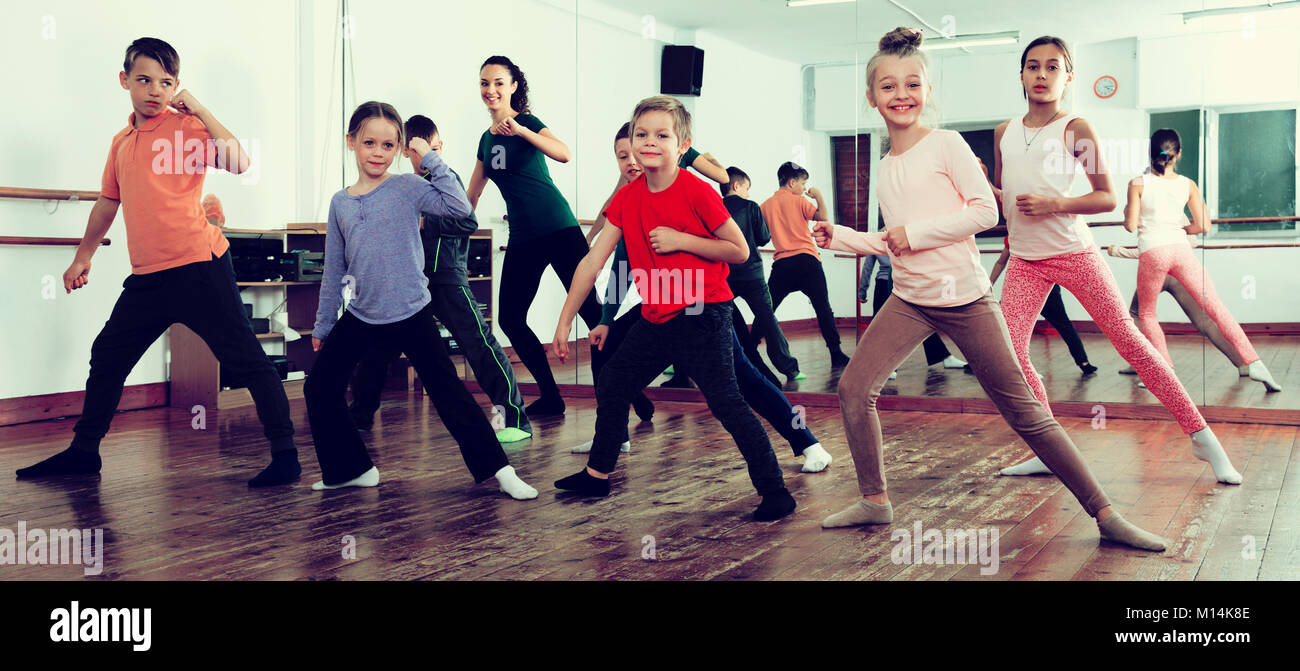 Smiling little children studying modern style dance in class Stock ...