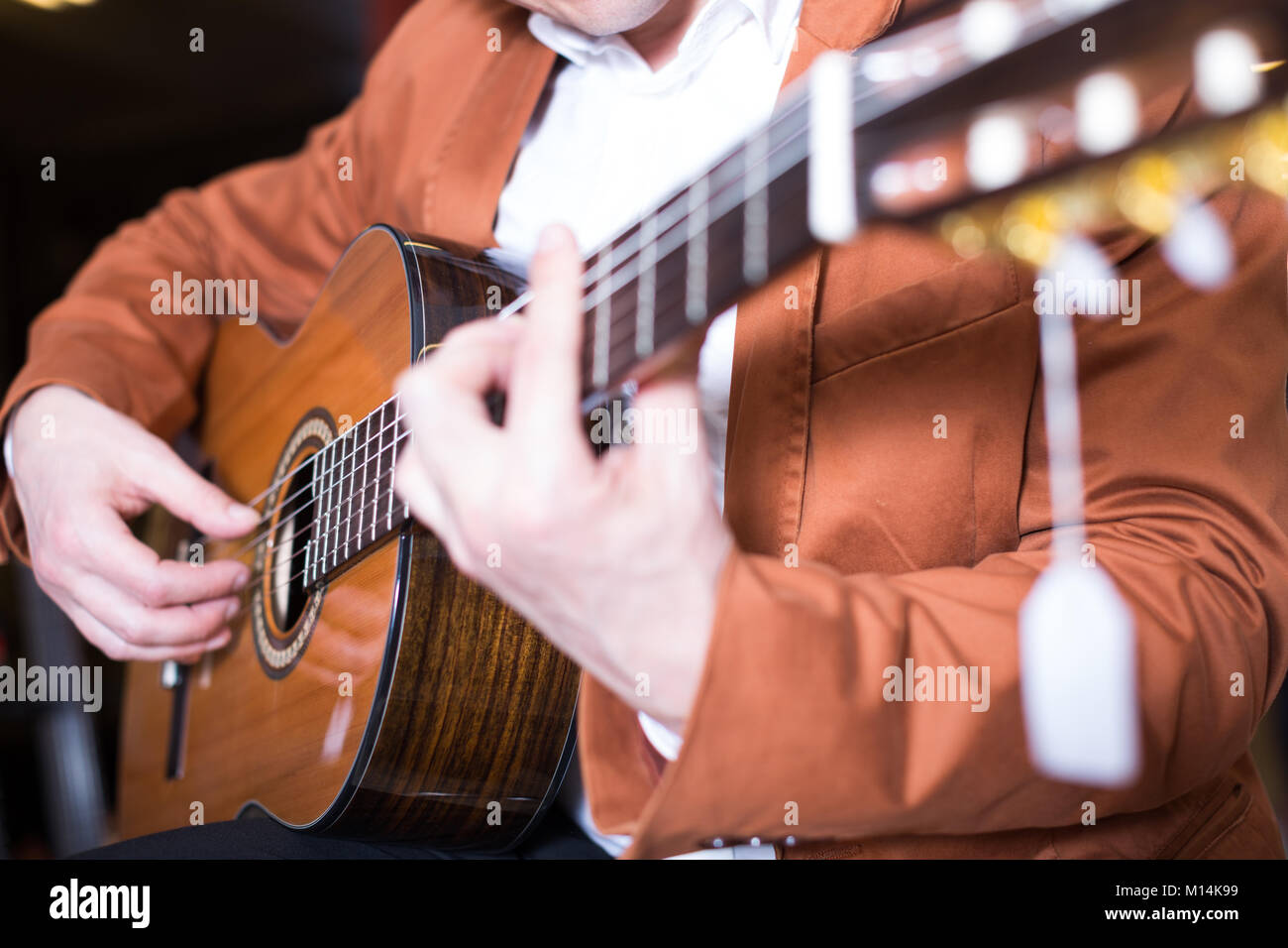Male musician performing with popular song on guitar at the concert ...