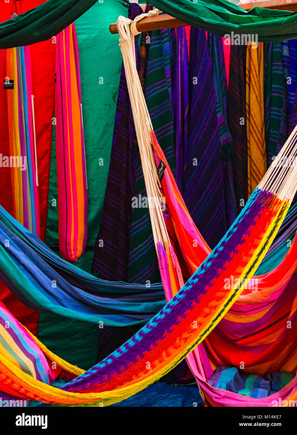 Rainbow colored fabrics, hanging in marketplace, woven Stock Photo - Alamy