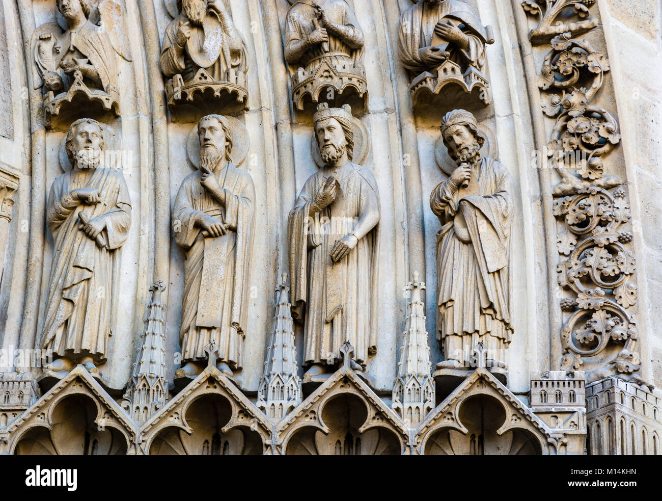 Paris, France: Statues of saints on the walls surrounding the doors of ...