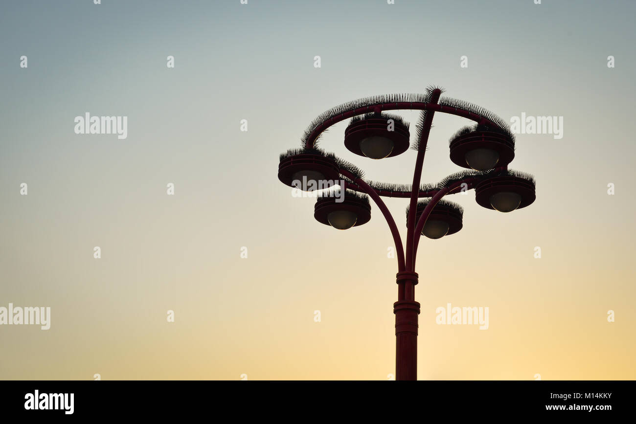 A big lamp post on main square of city under sunset sky Stock Photo - Alamy