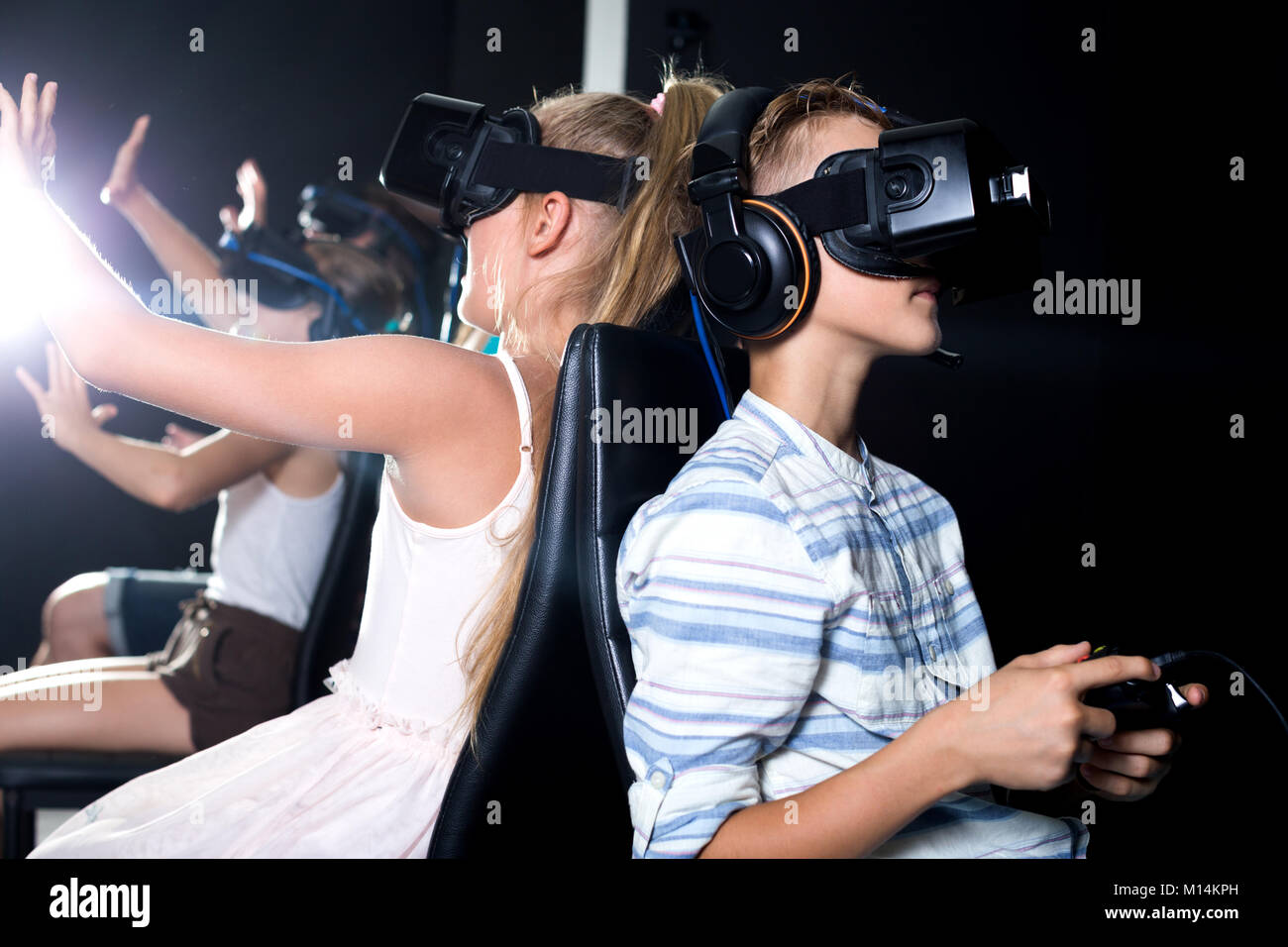 Family with children are watching video in VR room Stock Photo - Alamy