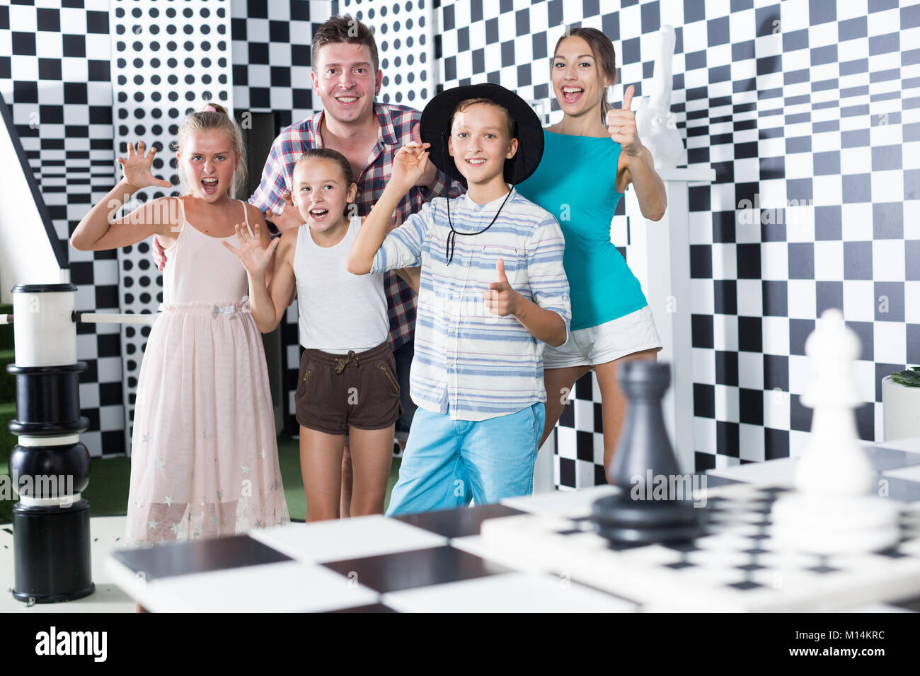 Young family is satisfied of visit together of lost chessroom Stock Photo - Alamy