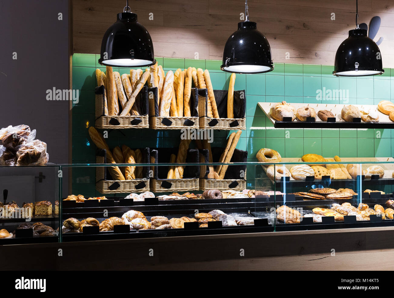 Modern design of bakery counter with bright lamps and glass showcase ...