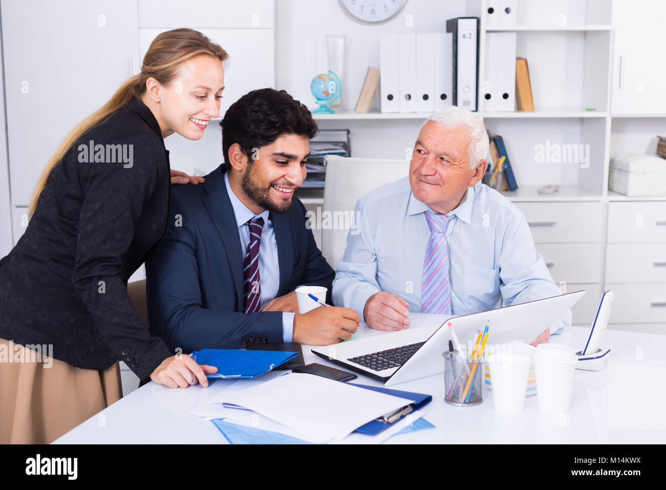 Employees are working together at computer in the office Stock Photo ...