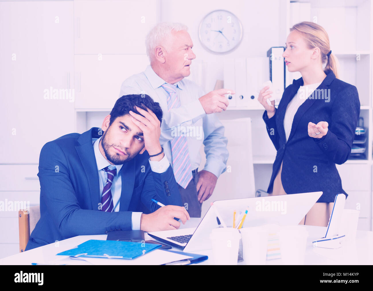 Mature businessman is chastising employees because of uncompleted work ...