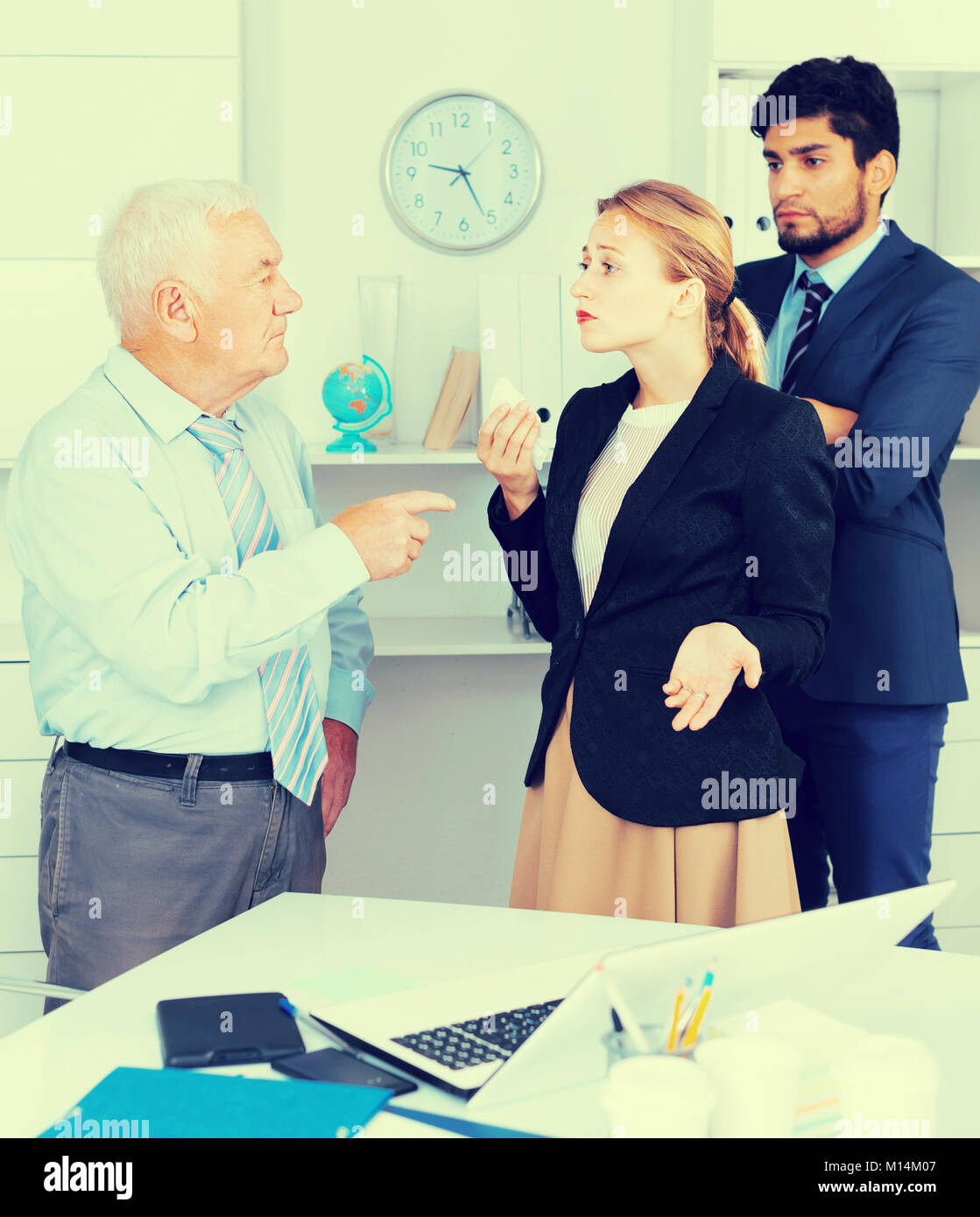 Mature businessman is chastising employees because of uncompleted work ...
