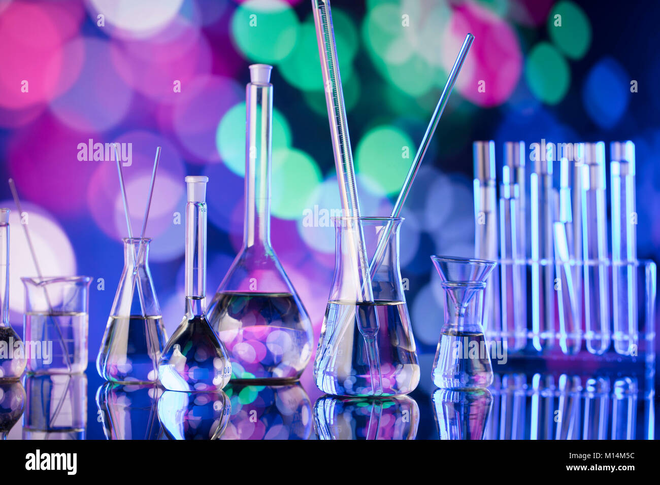 Science experiment concept background. Laboratory beakers, pipette ...