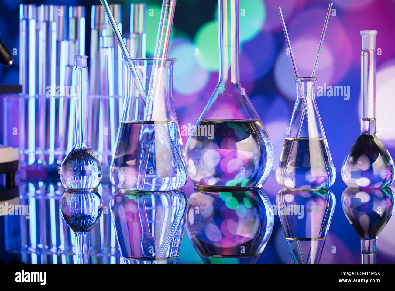 Science experiment concept background. Laboratory beakers, pipette ...