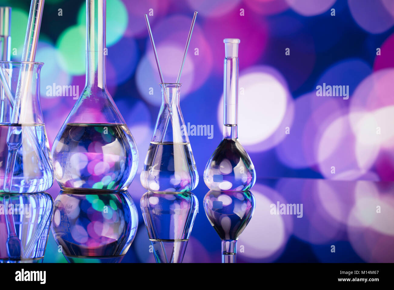Science experiment concept background. Laboratory beakers, pipette ...