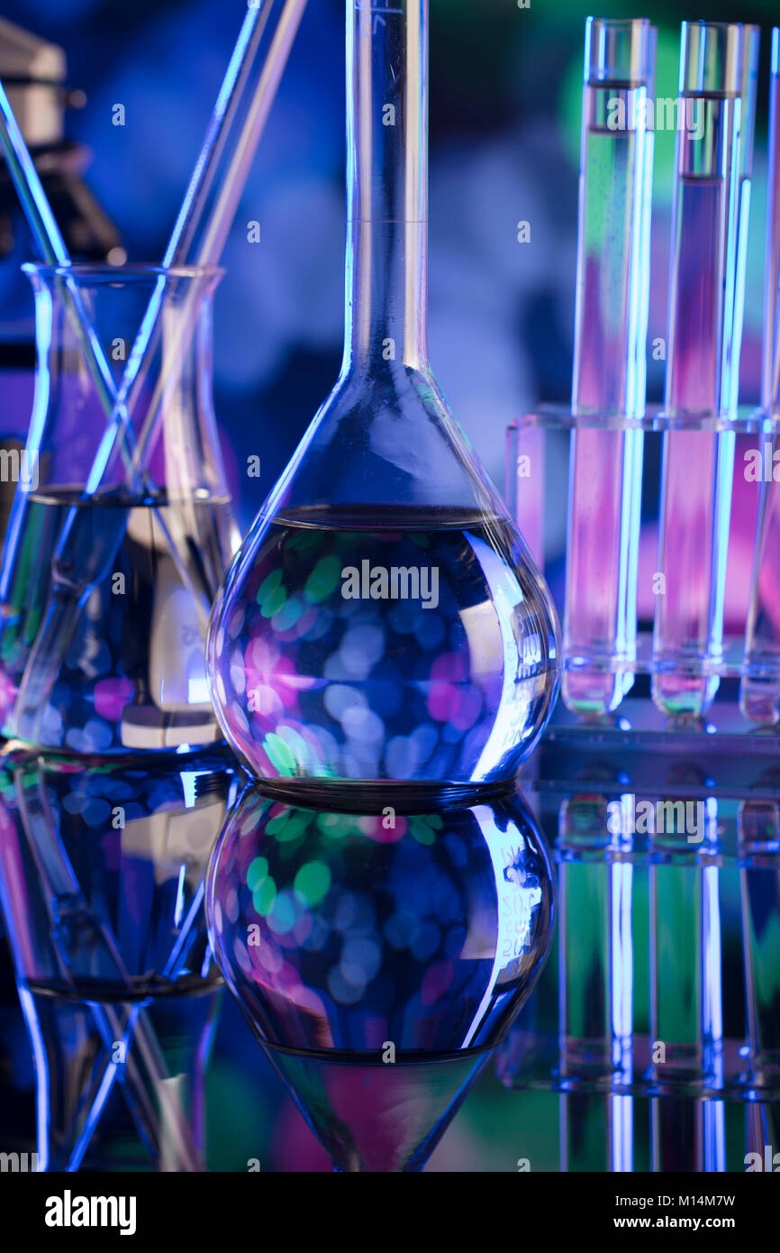 Science experiment concept background. Laboratory beakers, pipette ...