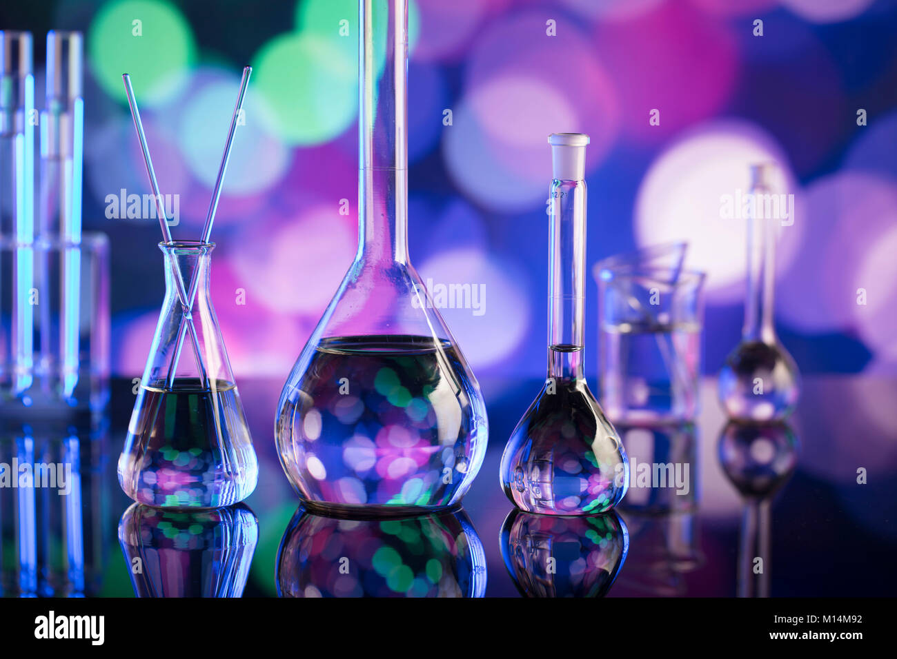 Science experiment concept background. Laboratory beakers, pipette ...
