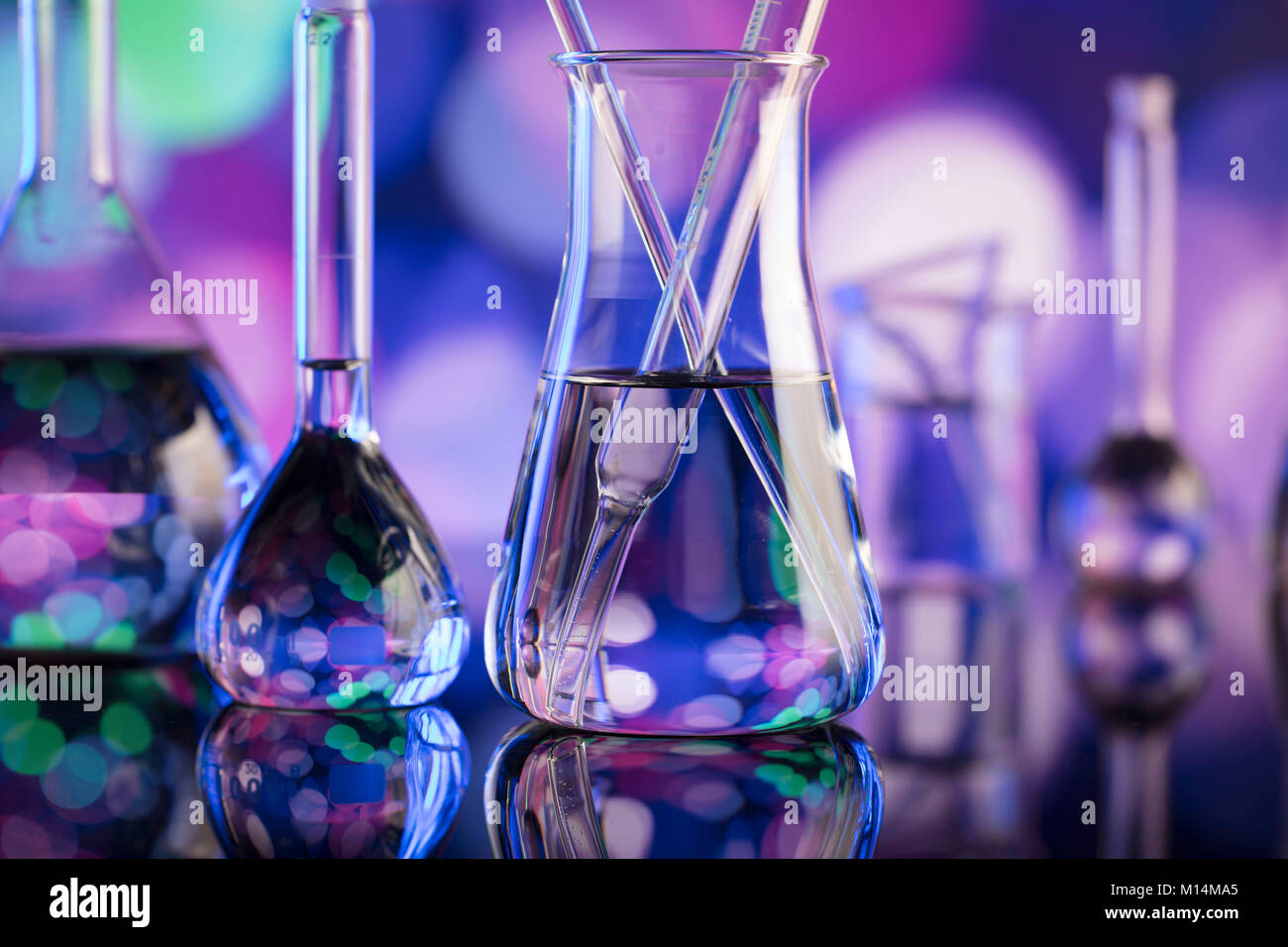 Science experiment concept background. Laboratory beakers, pipette ...