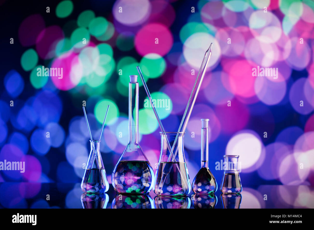 Science experiment concept background. Laboratory beakers, pipette ...