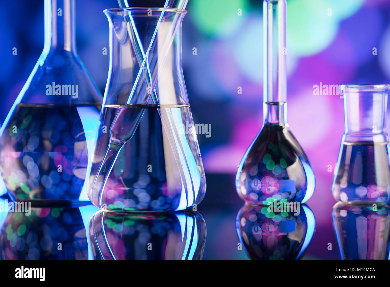Science experiment concept background. Laboratory beakers, pipette ...