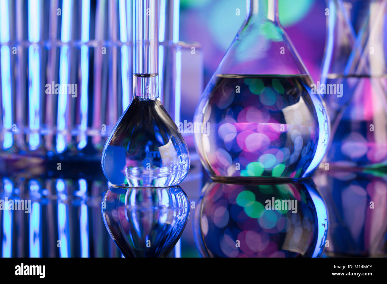 Science experiment concept background. Laboratory beakers, pipette ...