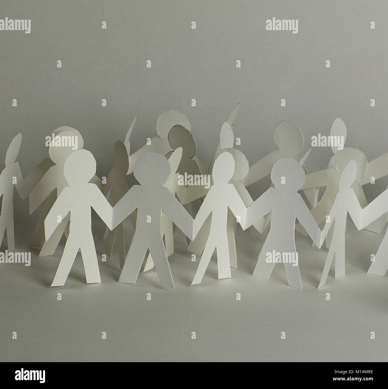 many paper men on the paper background.business background Stock Photo ...