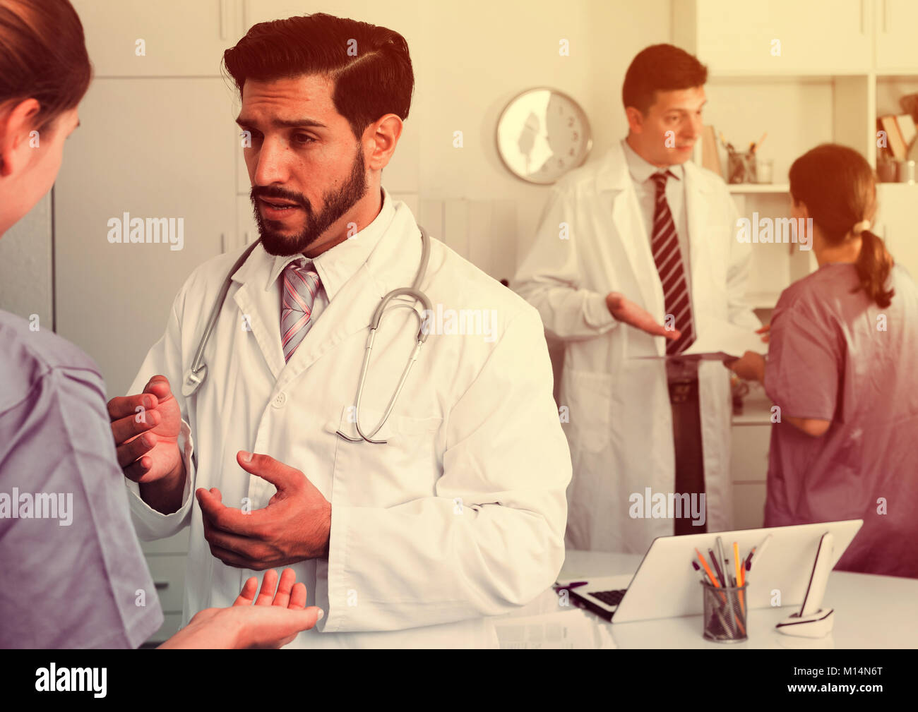 Doctors working patient discussing writing hi-res stock photography and ...