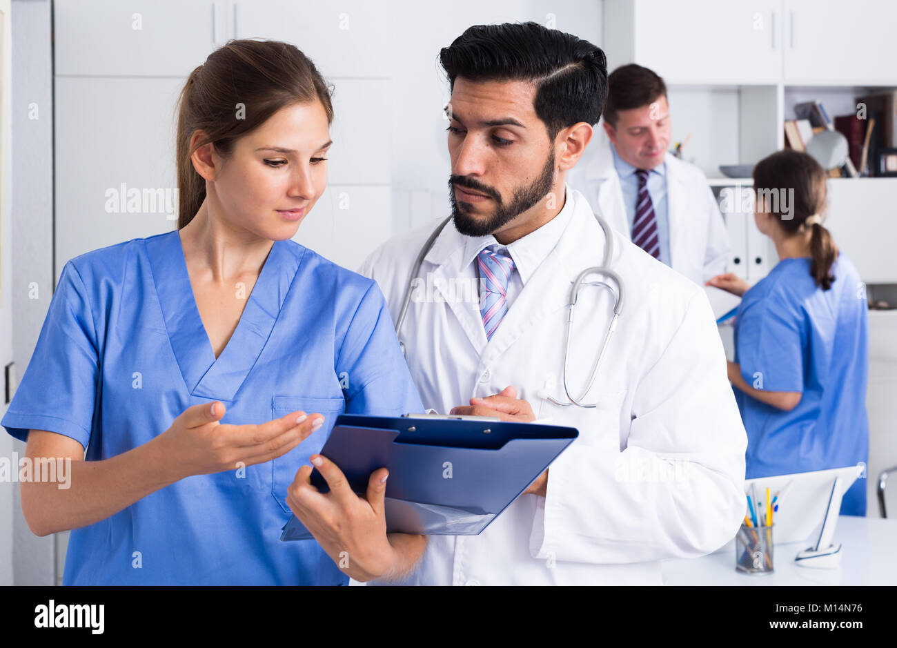 Experienced doctors discussing medical issues in office Stock Photo - Alamy