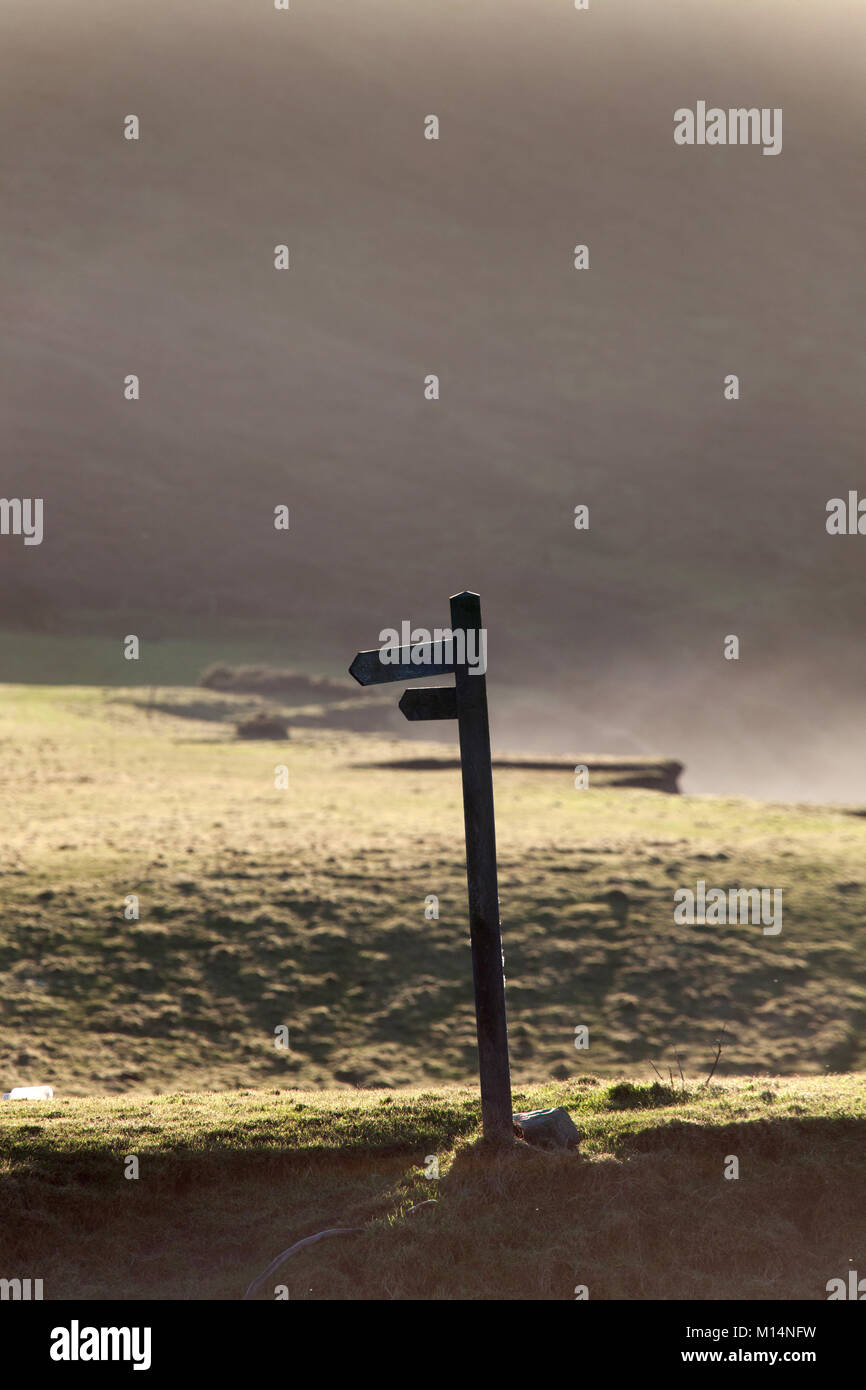 The Wales Coast Path. Silhouetted view of a route sign on the Wales and ...