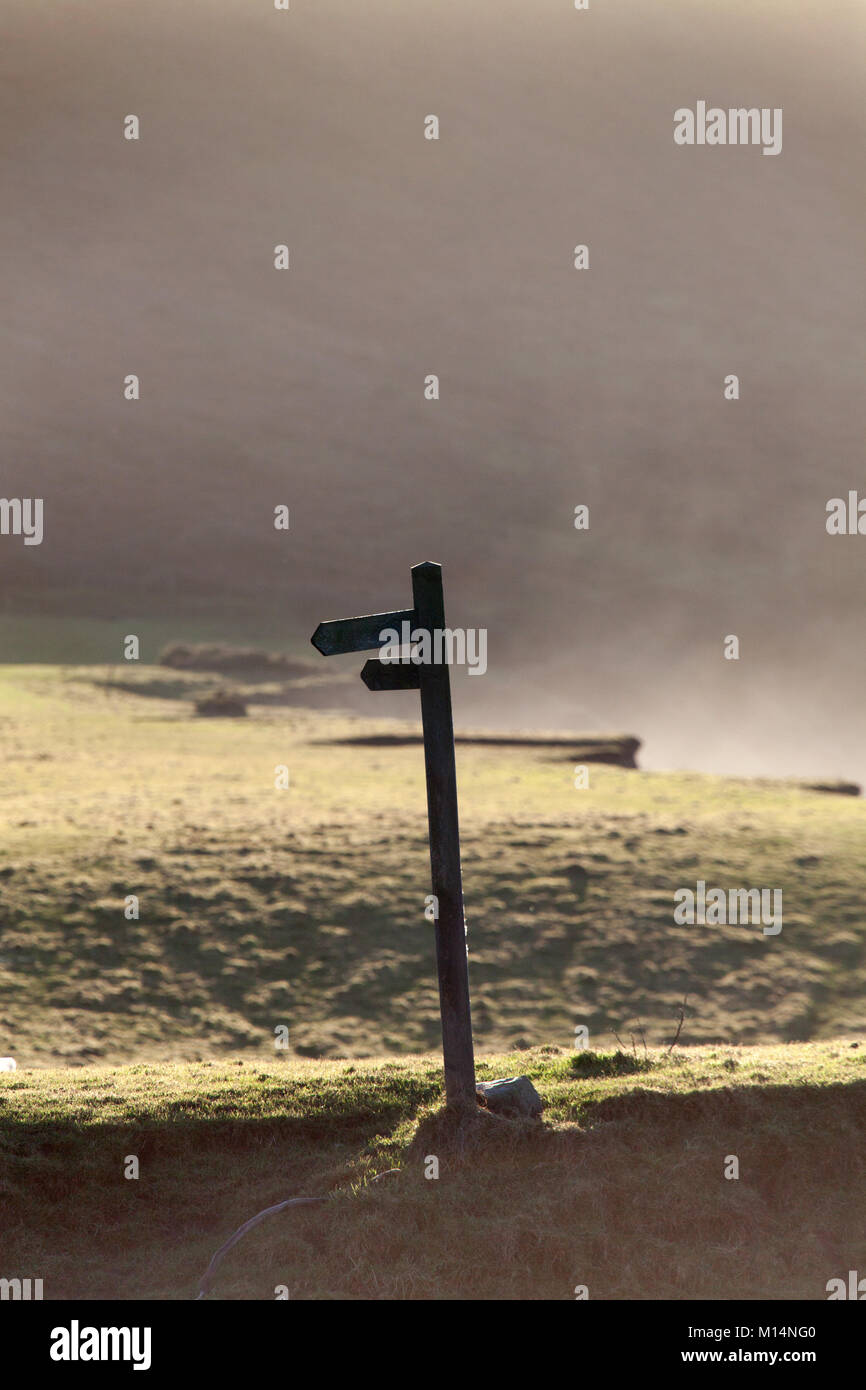 The Wales Coast Path. Silhouetted view of a route sign on the Wales and ...