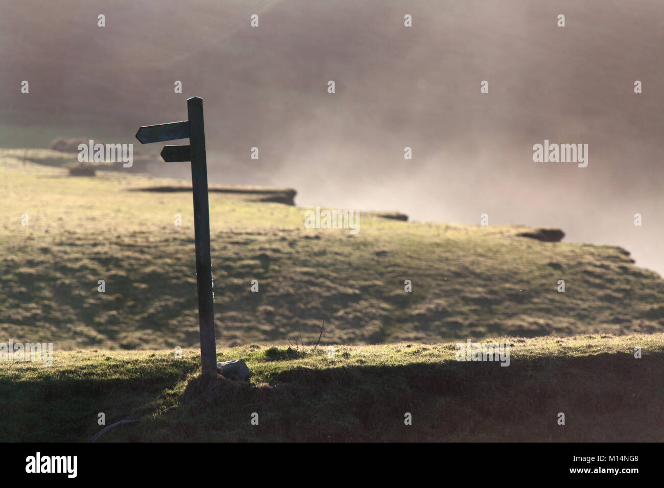 The Wales Coast Path. Silhouetted view of a route sign on the Wales and ...
