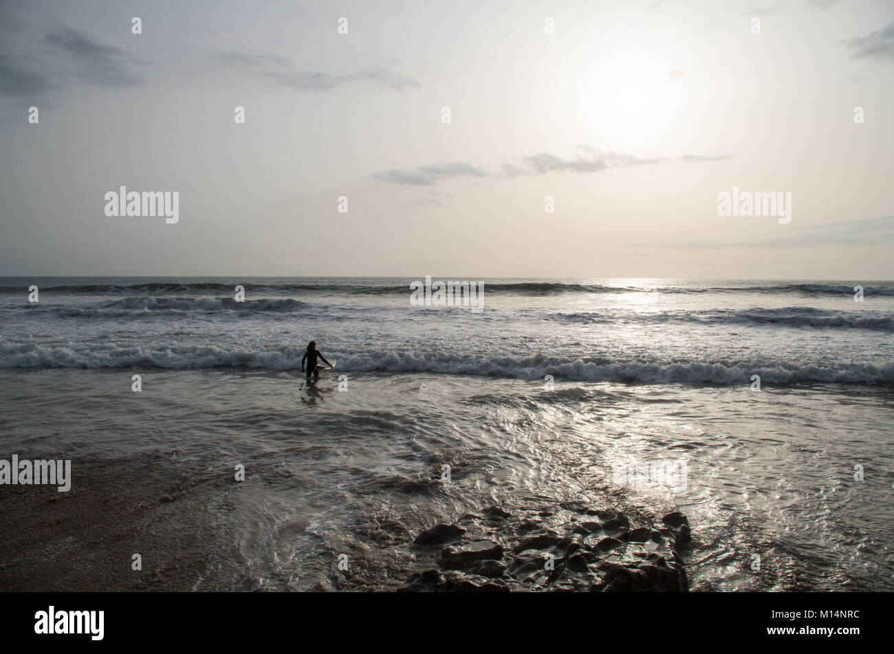 Surfer going into the water Stock Photo - Alamy