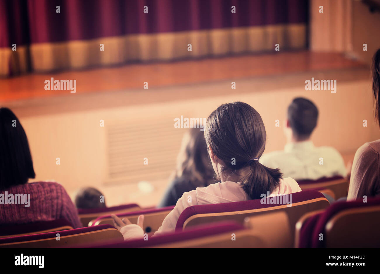 Positive audience expecting movie to begin in cinema Stock Photo - Alamy