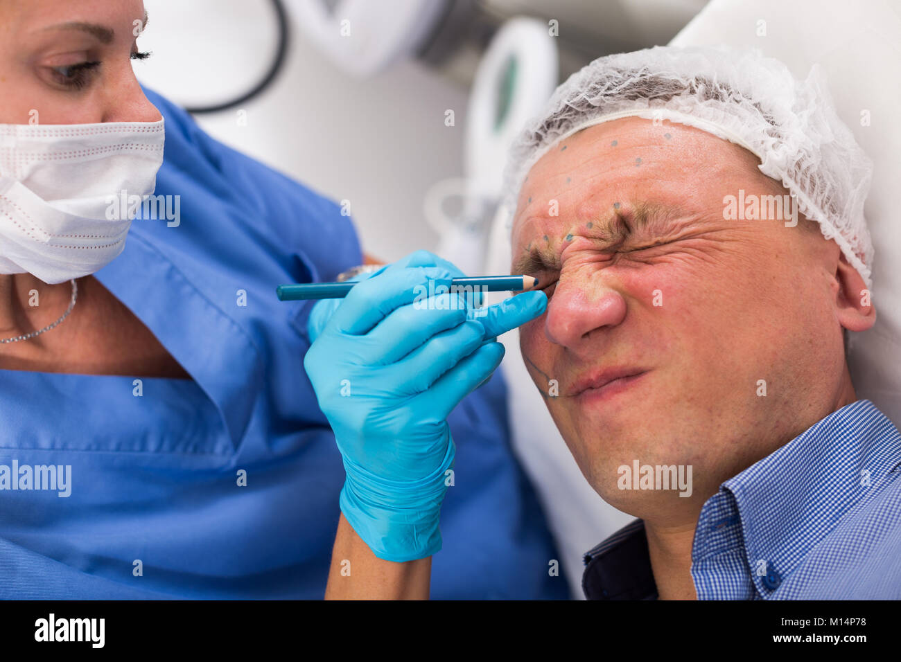 Female doctor is preparing patient for procedure with using marker in ...