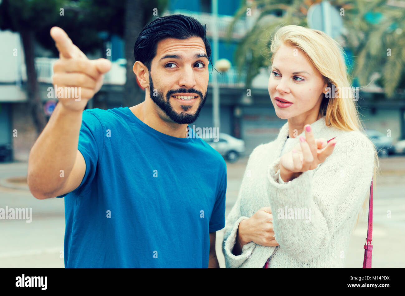 Man is asking woman stranger about road to hotel in the city Stock ...