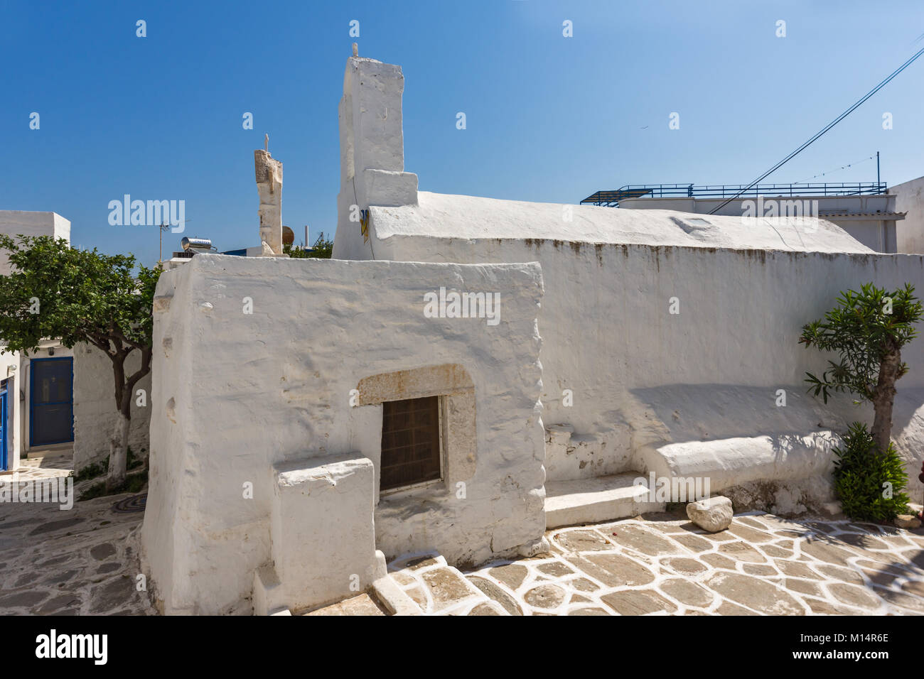 White chuch and street in town of Parakia, Paros island, Cyclades ...