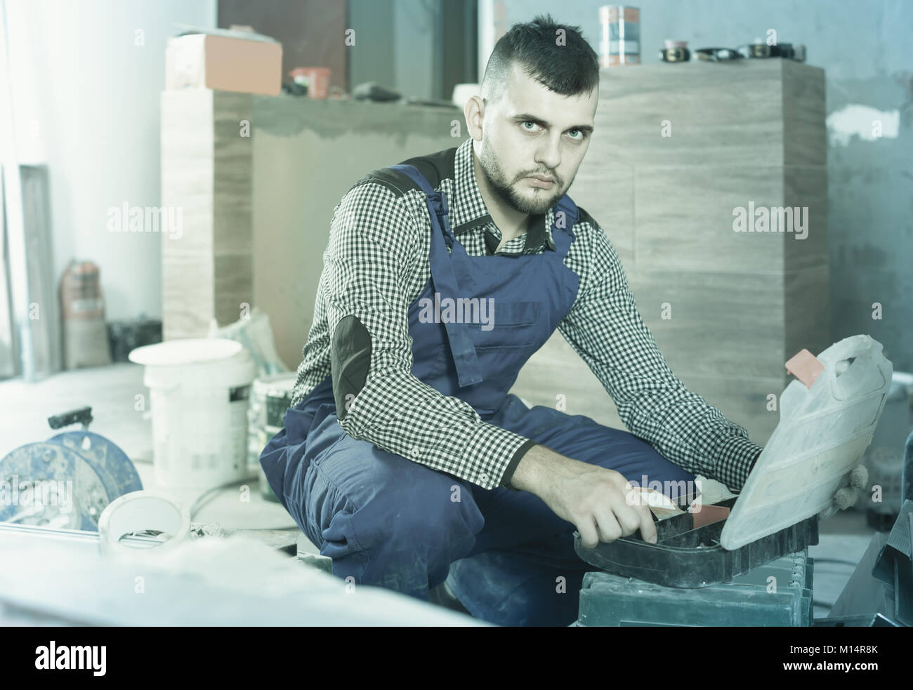 happy american worker is choosing tools in suitcase for work at the ...