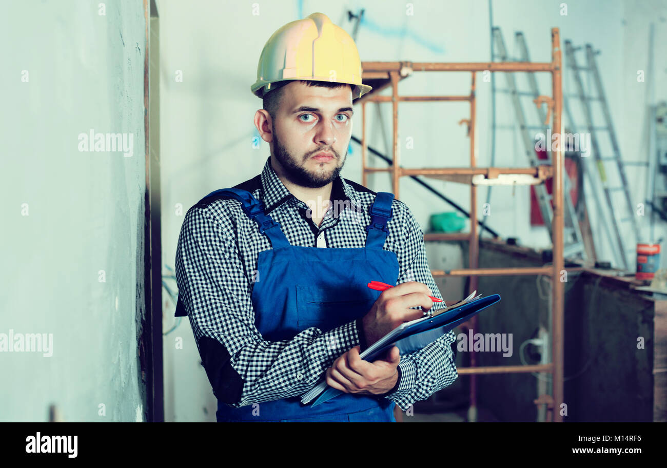 Professional builder is signing documents about the report at home ...