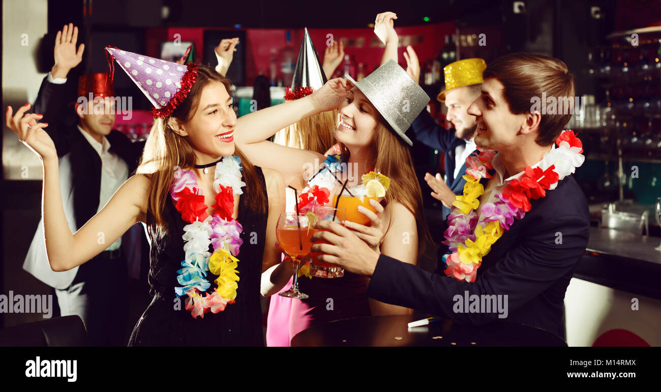 Young men and women celebrating birthday in the bar at evening Stock ...