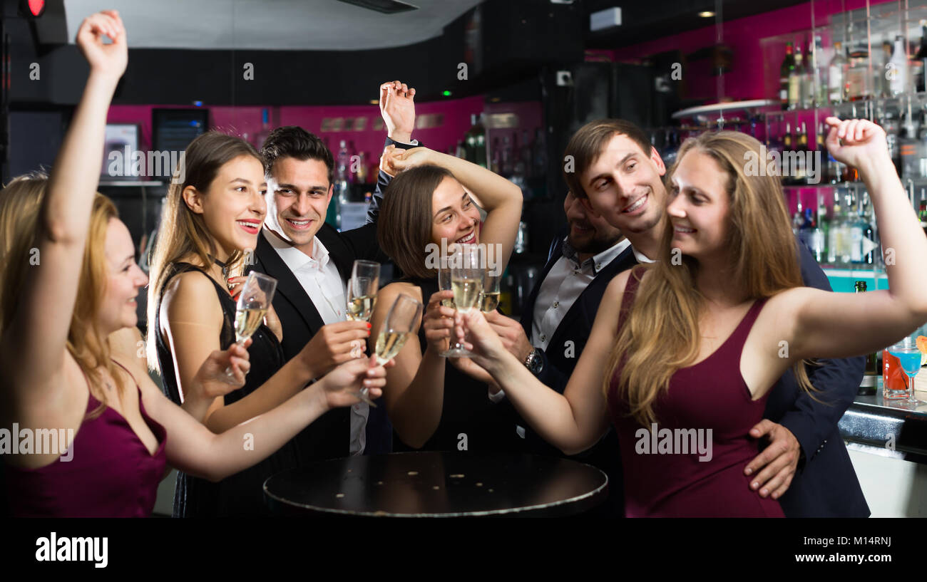 Cheerful colleagues dancing on corporate party with cocktails Stock ...