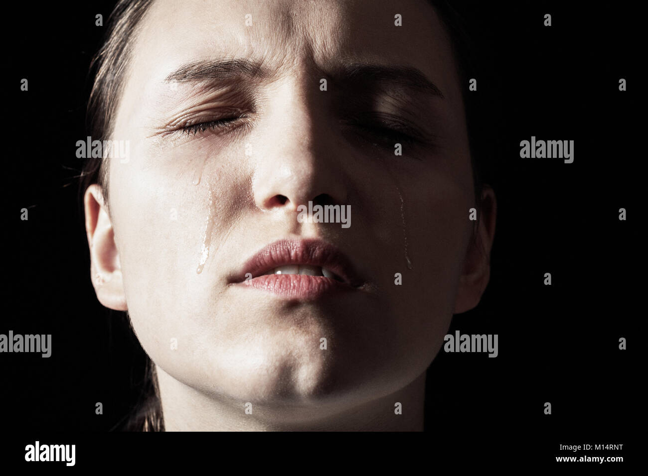 sad woman crying on black background, closeup portrait Stock Photo - Alamy
