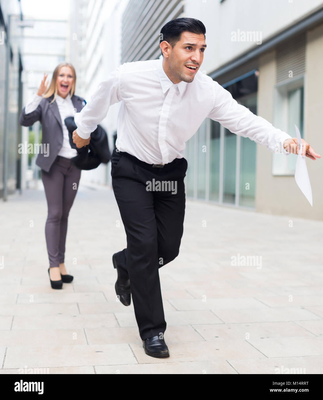 Manager is running away from angry woman boss outdoors Stock Photo - Alamy